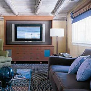 Sitting area with couch, chair and TV.